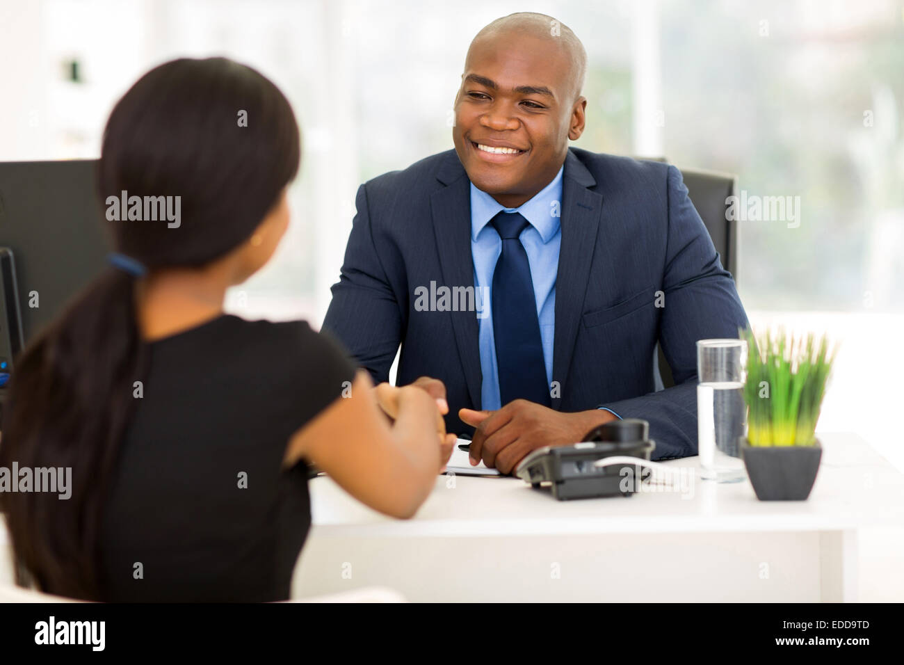 successful African American businessman handshaking with client in ...