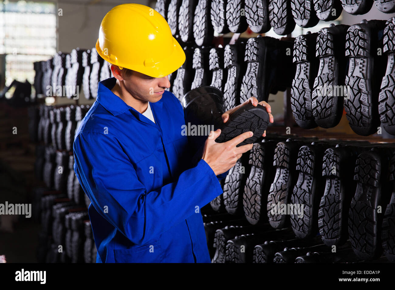 quality controller checking rubber-boots sole in storeroom Stock Photo ...
