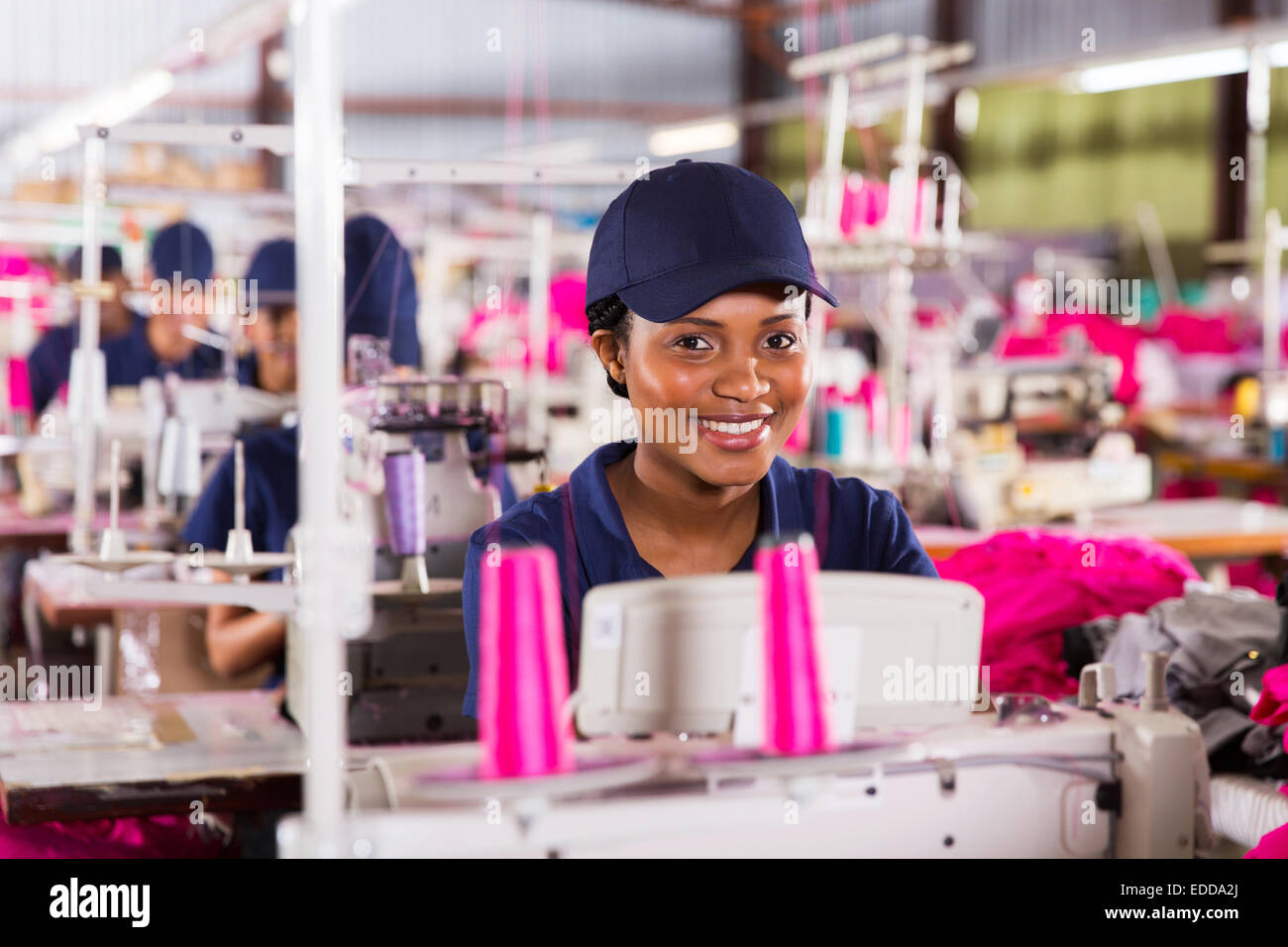 pretty African textile worker sewing Stock Photo - Alamy