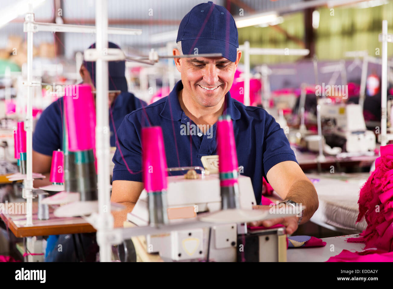 Happy sewing factory worker hi-res stock photography and images - Alamy