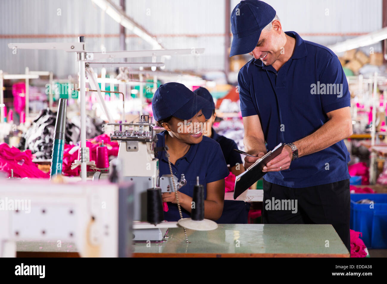 happy textile factory supervisor recording machinist performance Stock ...