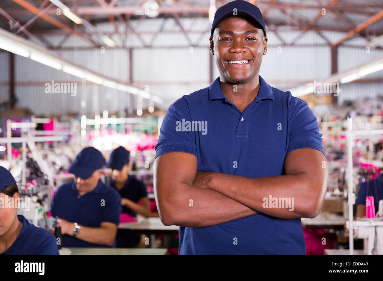 handsome African American factory supervisor with machinists on ...