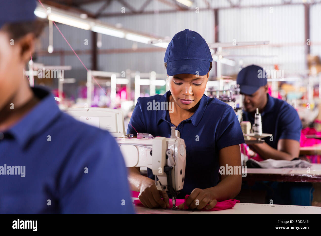African textile factory machinist working in production line Stock ...