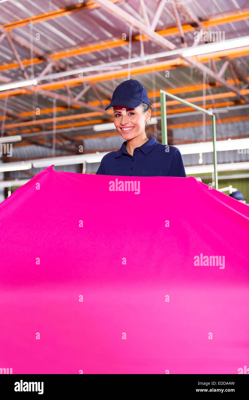 cheerful young textile factory worker holding large pink fabric Stock ...