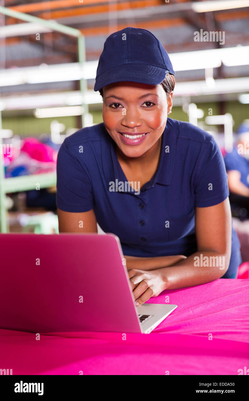 pretty African clothing factory designer using laptop computer Stock ...