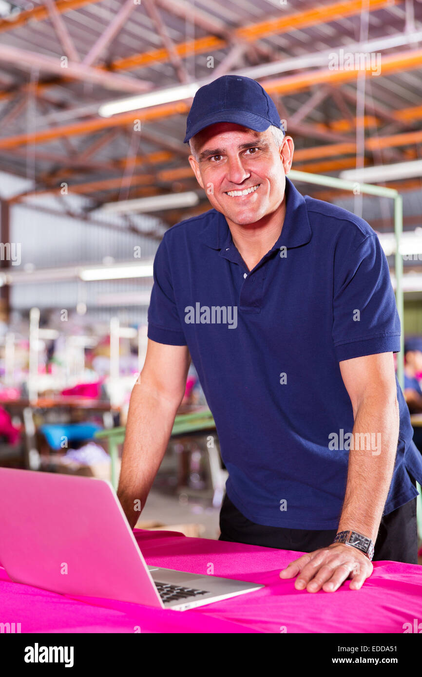 happy middle aged textile factory worker using computer Stock Photo - Alamy