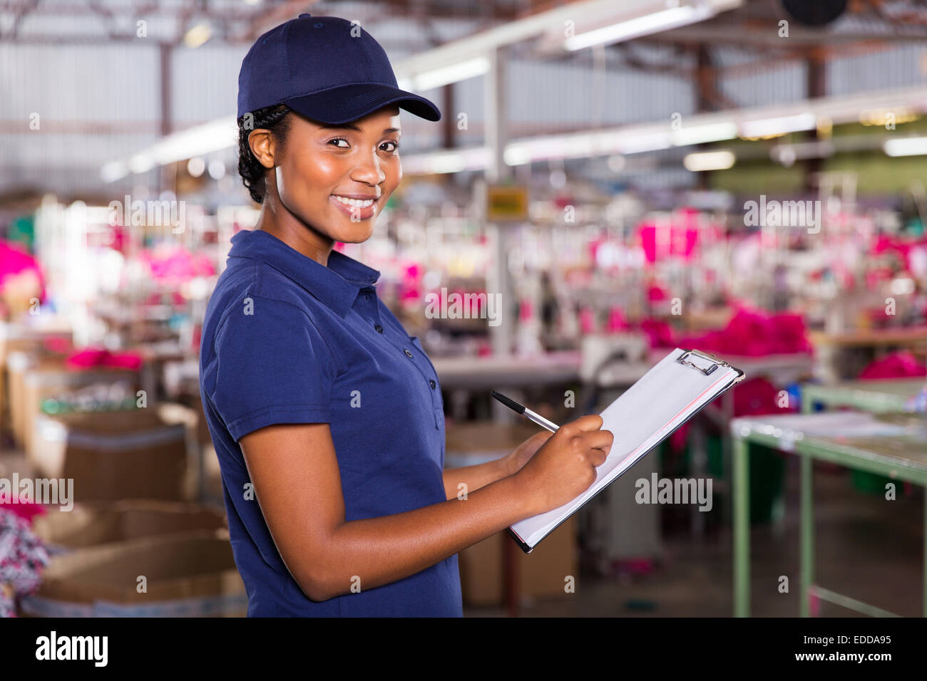 young female African textile factory worker in production area Stock ...