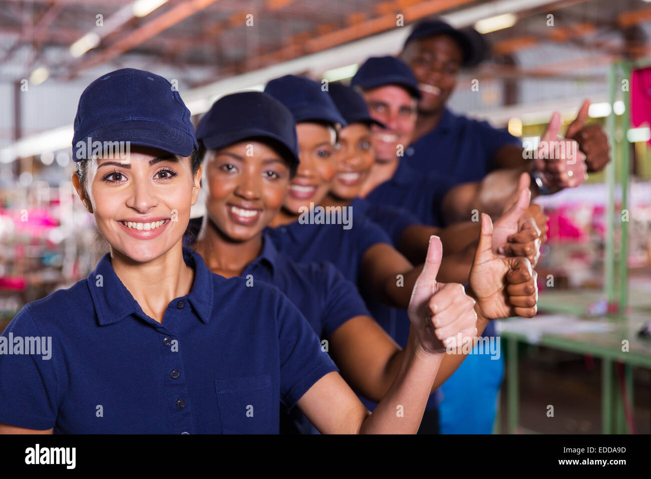 cheerful textile workers team giving thumbs up Stock Photo - Alamy