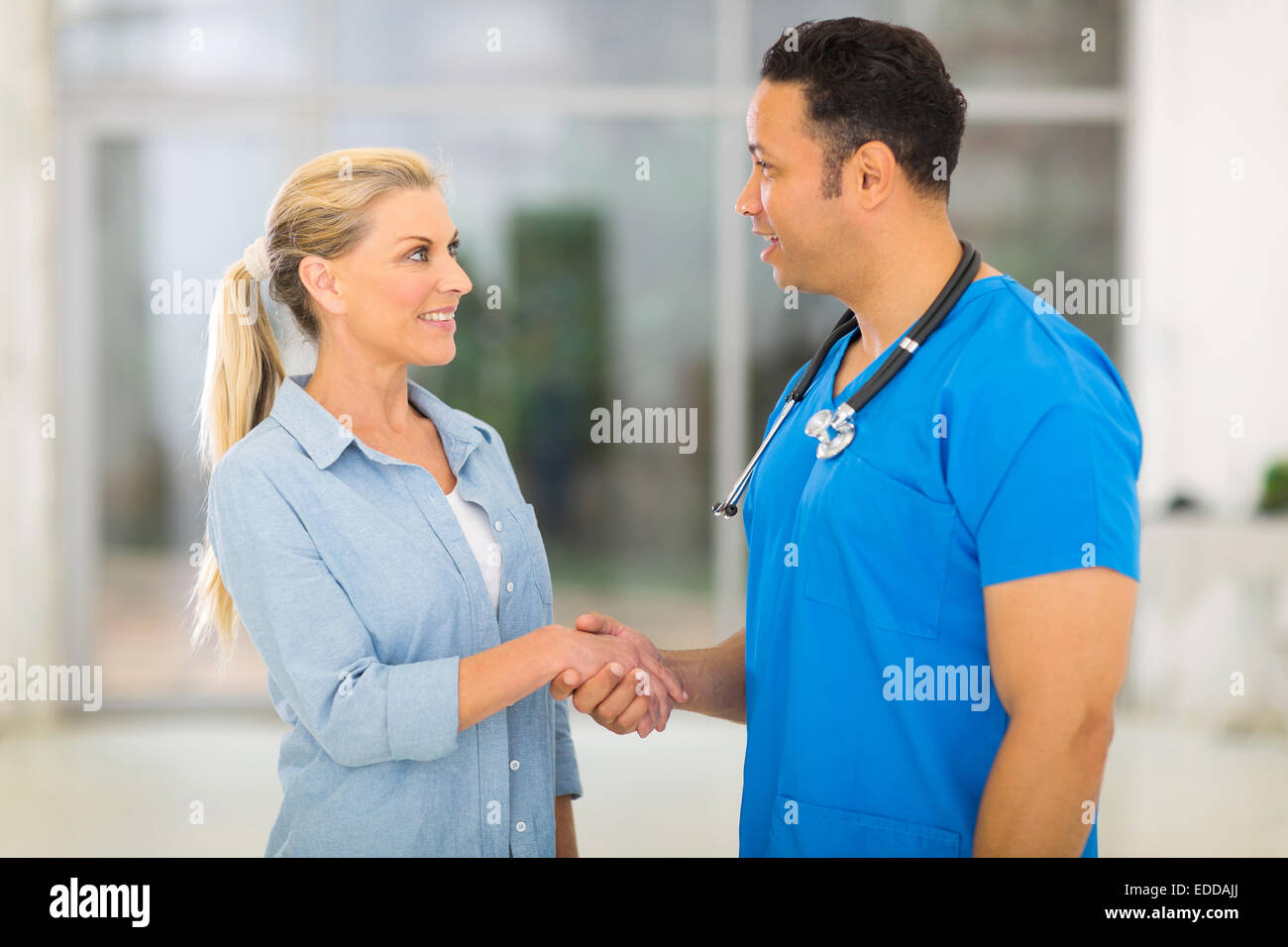 caring medical doctor greeting senior patient Stock Photo - Alamy