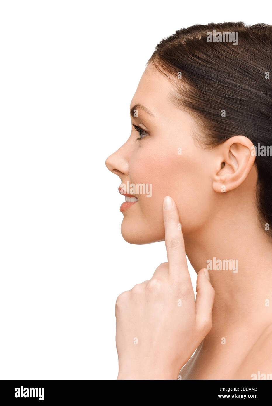 smiling young woman pointing to her cheek Stock Photo - Alamy
