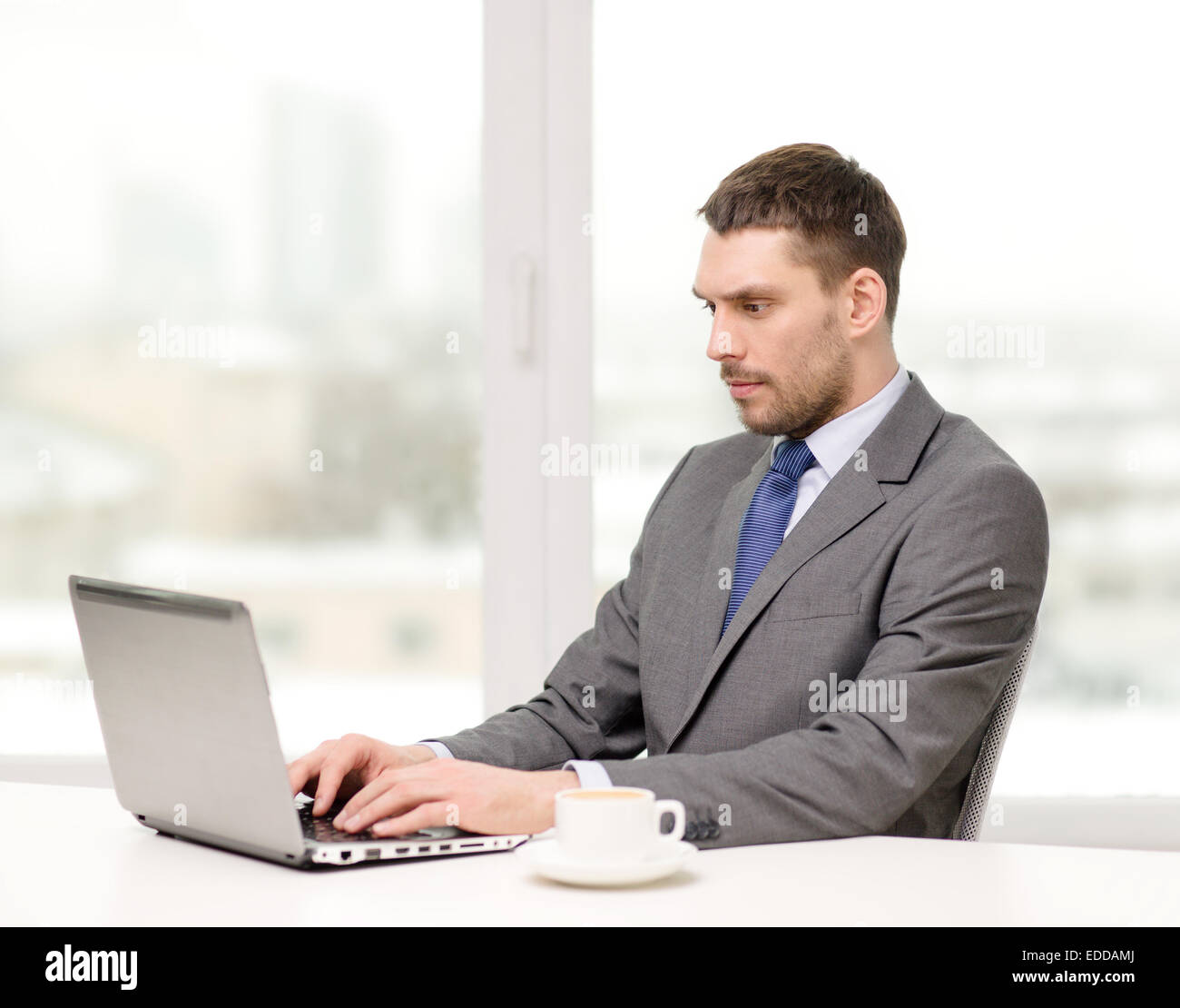 busy businessman with laptop and coffee Stock Photo - Alamy