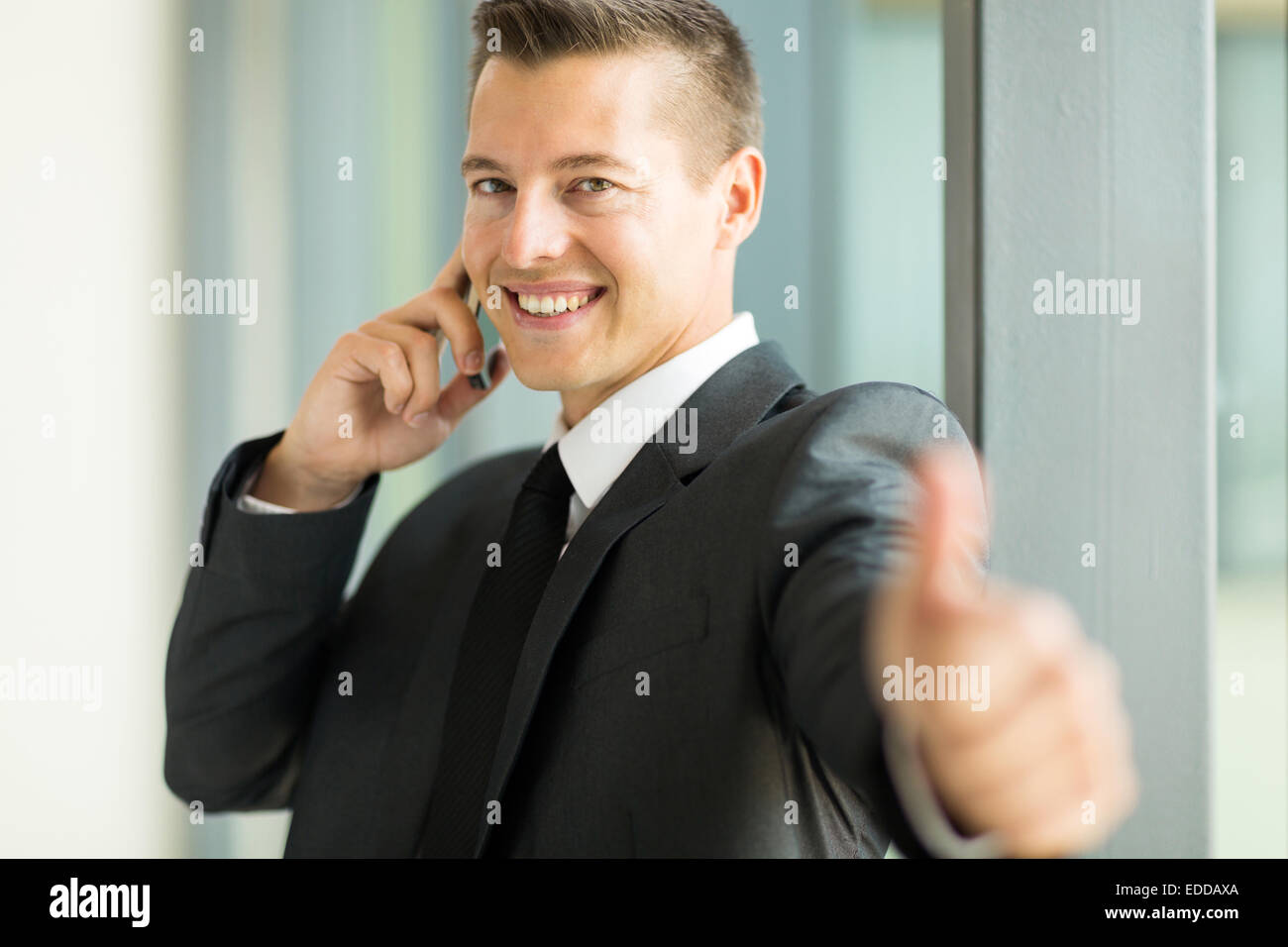 happy businessman talking on cell phone and giving thumb up Stock Photo ...