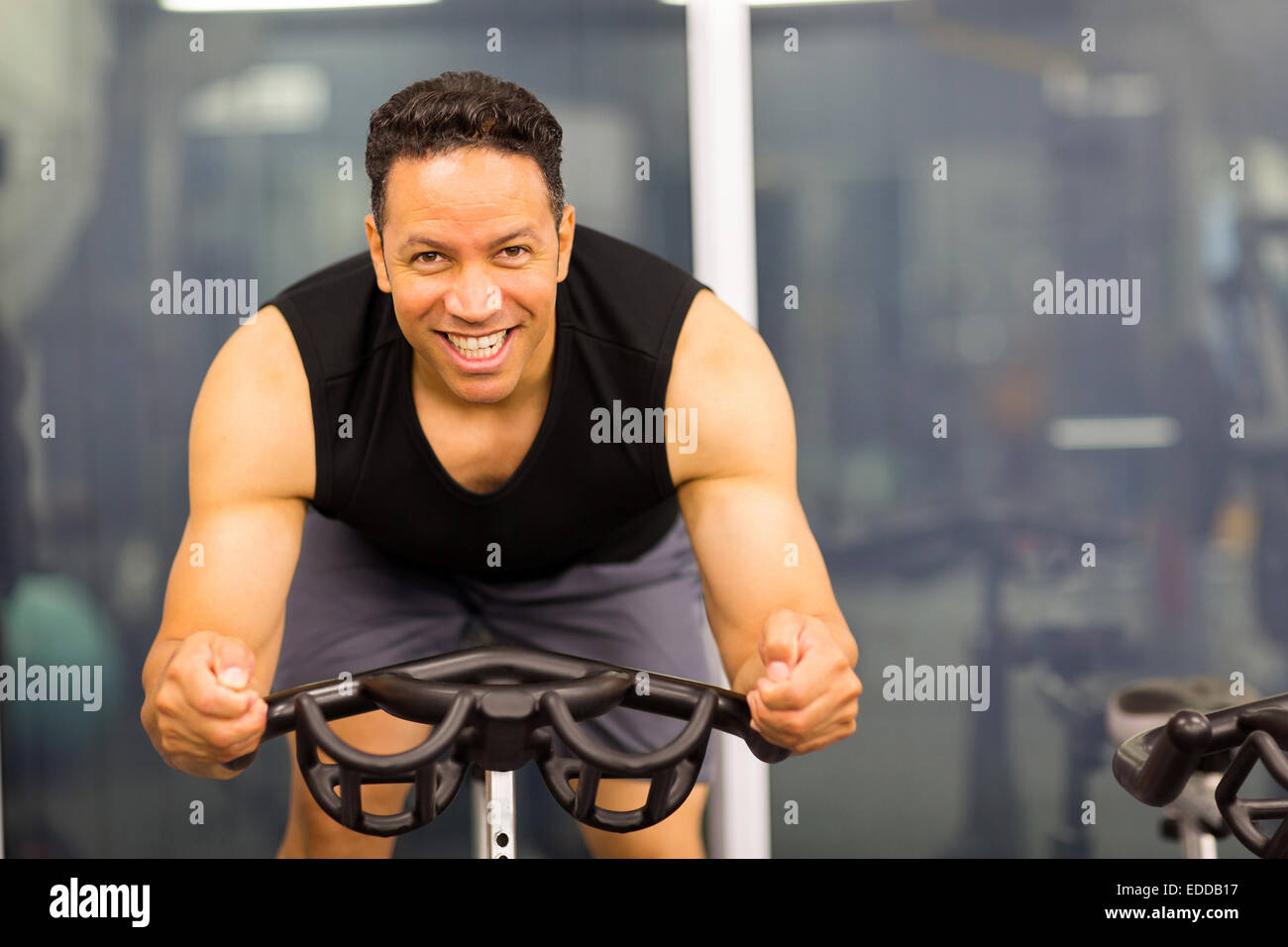 handsome mid age male cyclist on gym bike Stock Photo - Alamy