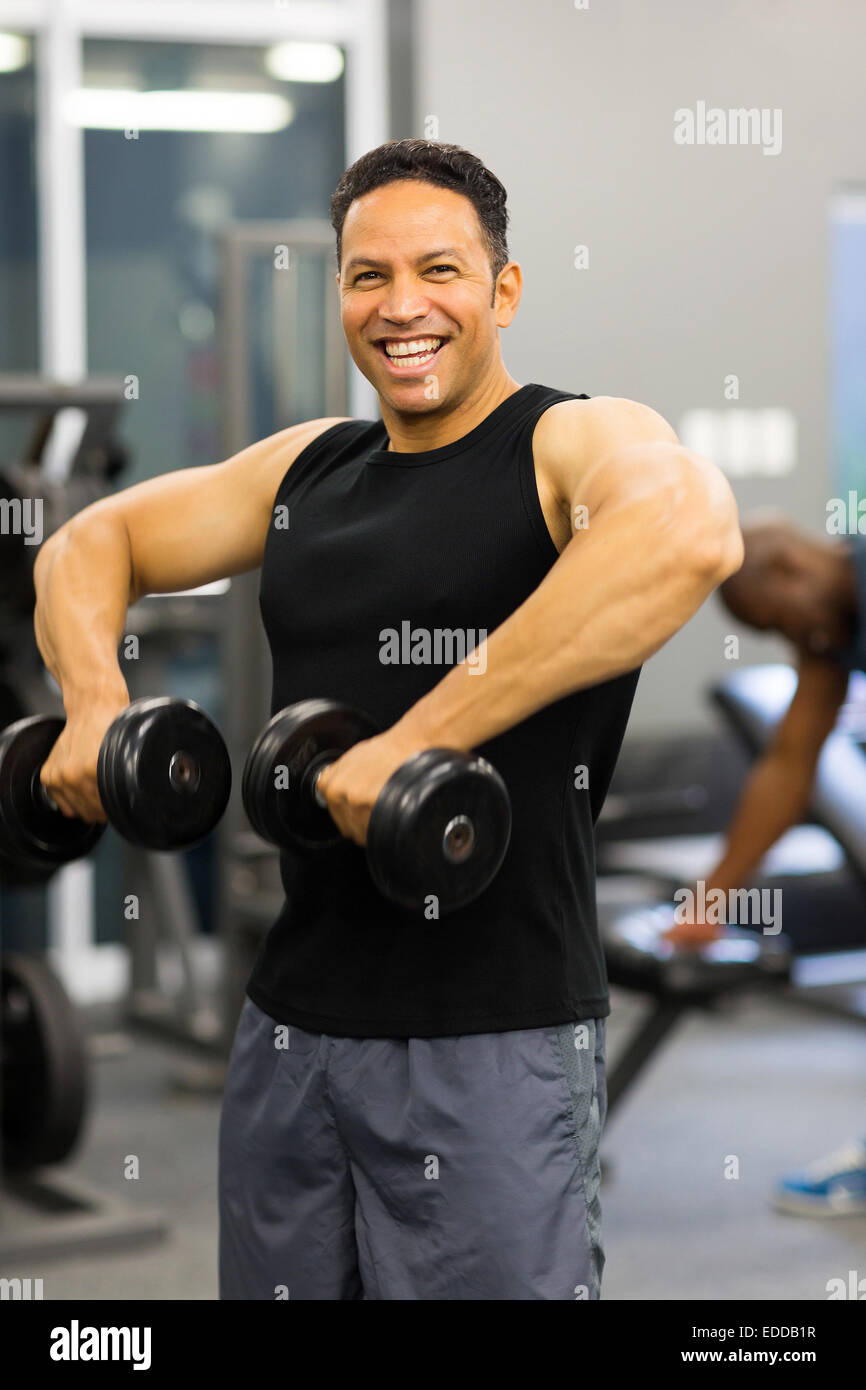 Muscular man lifting dumbbells hi-res stock photography and images - Alamy