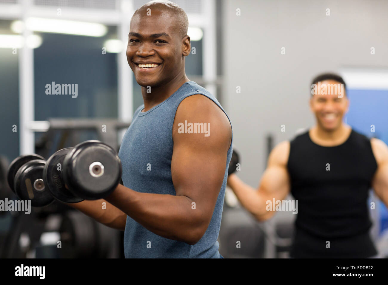healthy African man working out with dumbbells in gym Stock Photo - Alamy