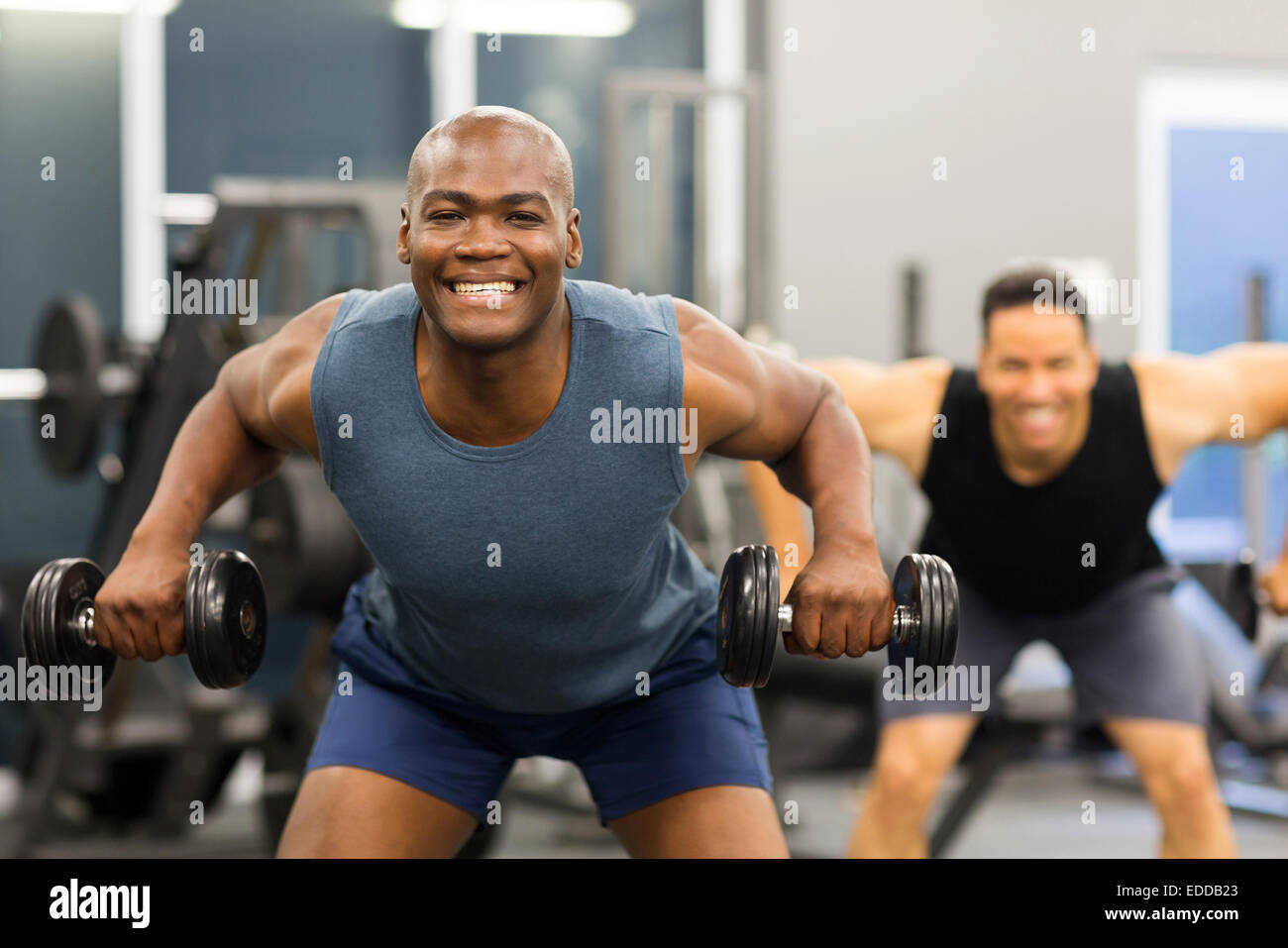 happy African man exercising in gym with dumbbells Stock Photo - Alamy