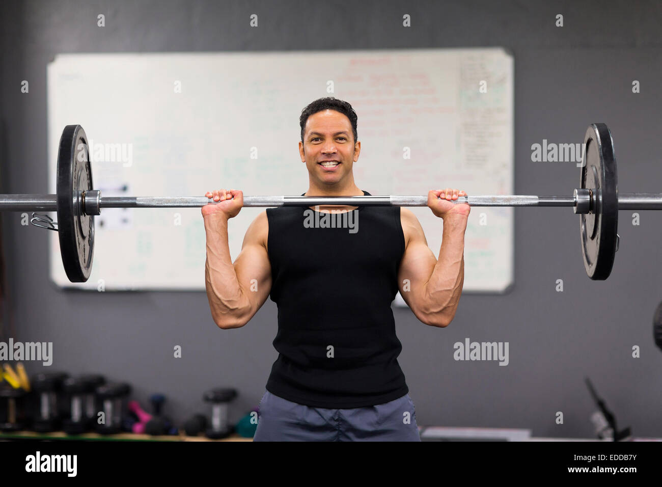 Strong handsome bodybuilder lifting weights hi-res stock photography ...