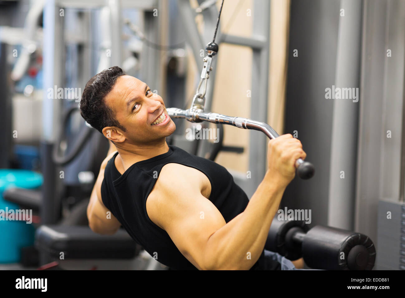 handsome mid age man doing pull-down workout in gym Stock Photo - Alamy