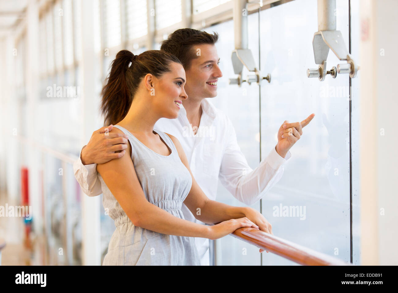 happy young couple at restaurant pointing outside Stock Photo - Alamy