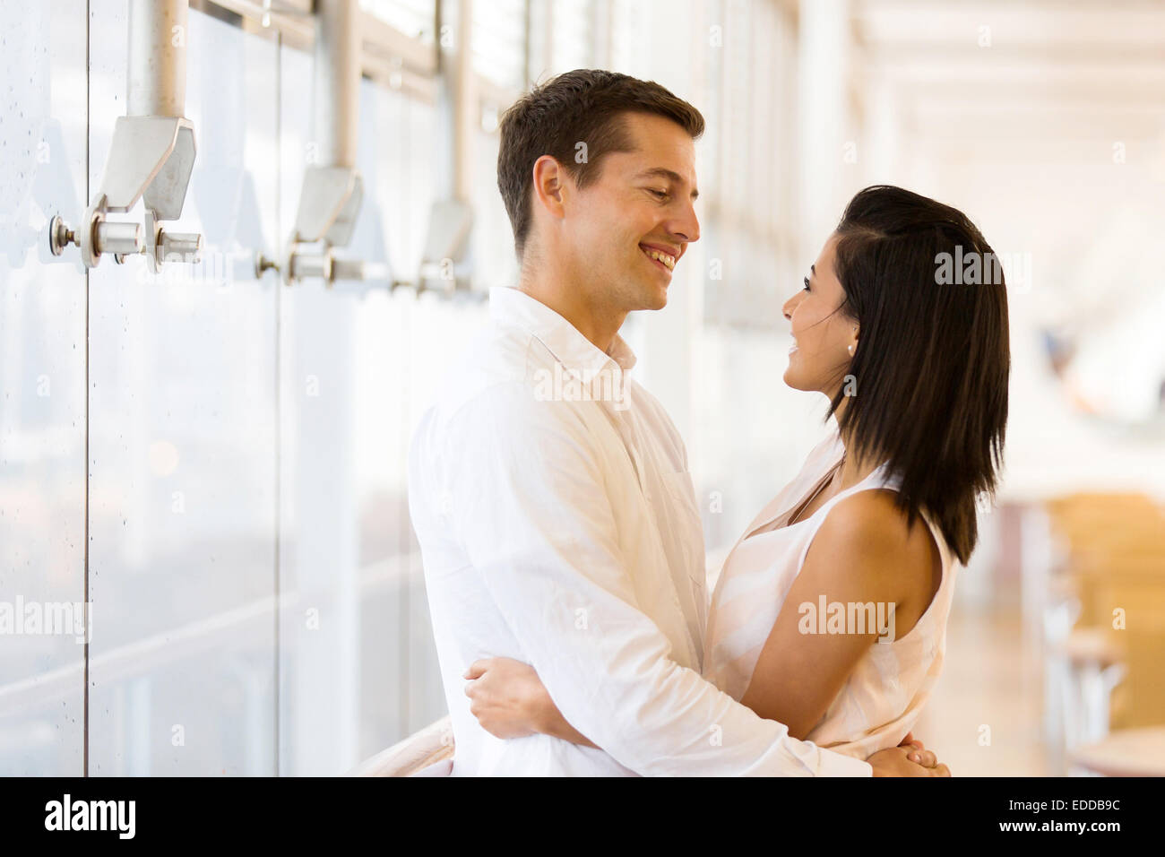 cheerful young couple talking to each other Stock Photo - Alamy