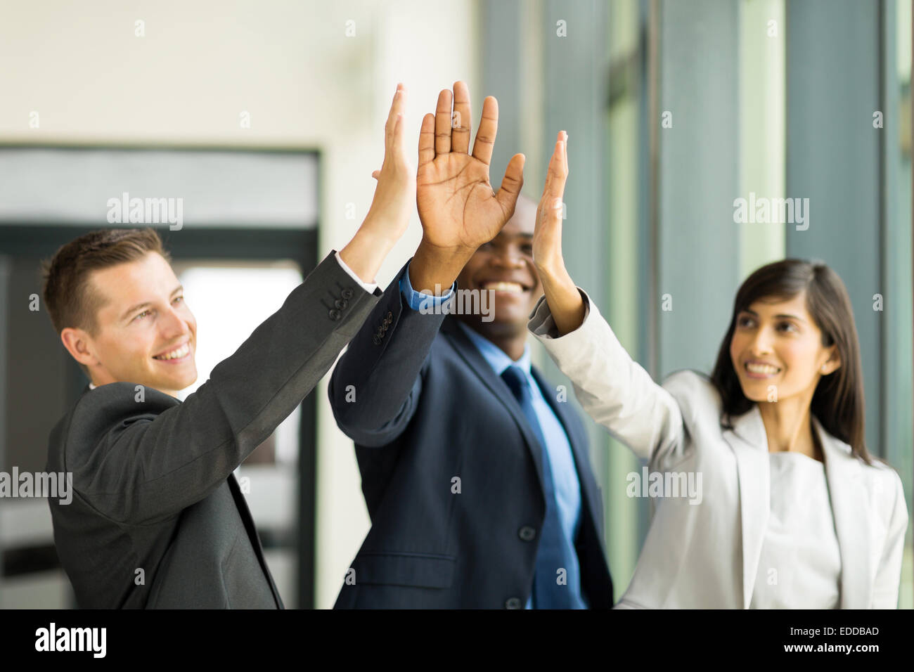 happy business team giving high five in office Stock Photo - Alamy