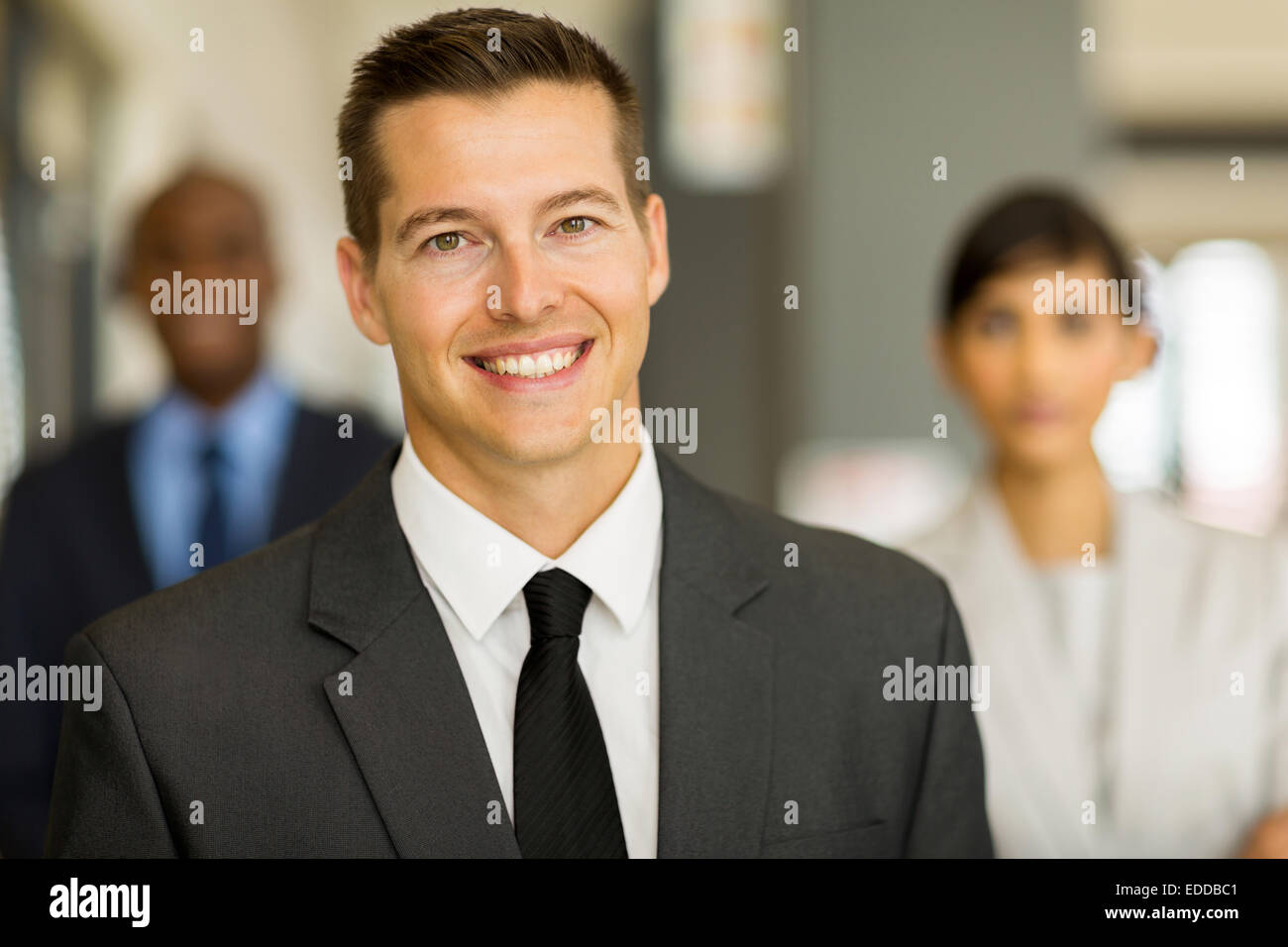 good looking young business man with colleagues on background Stock ...