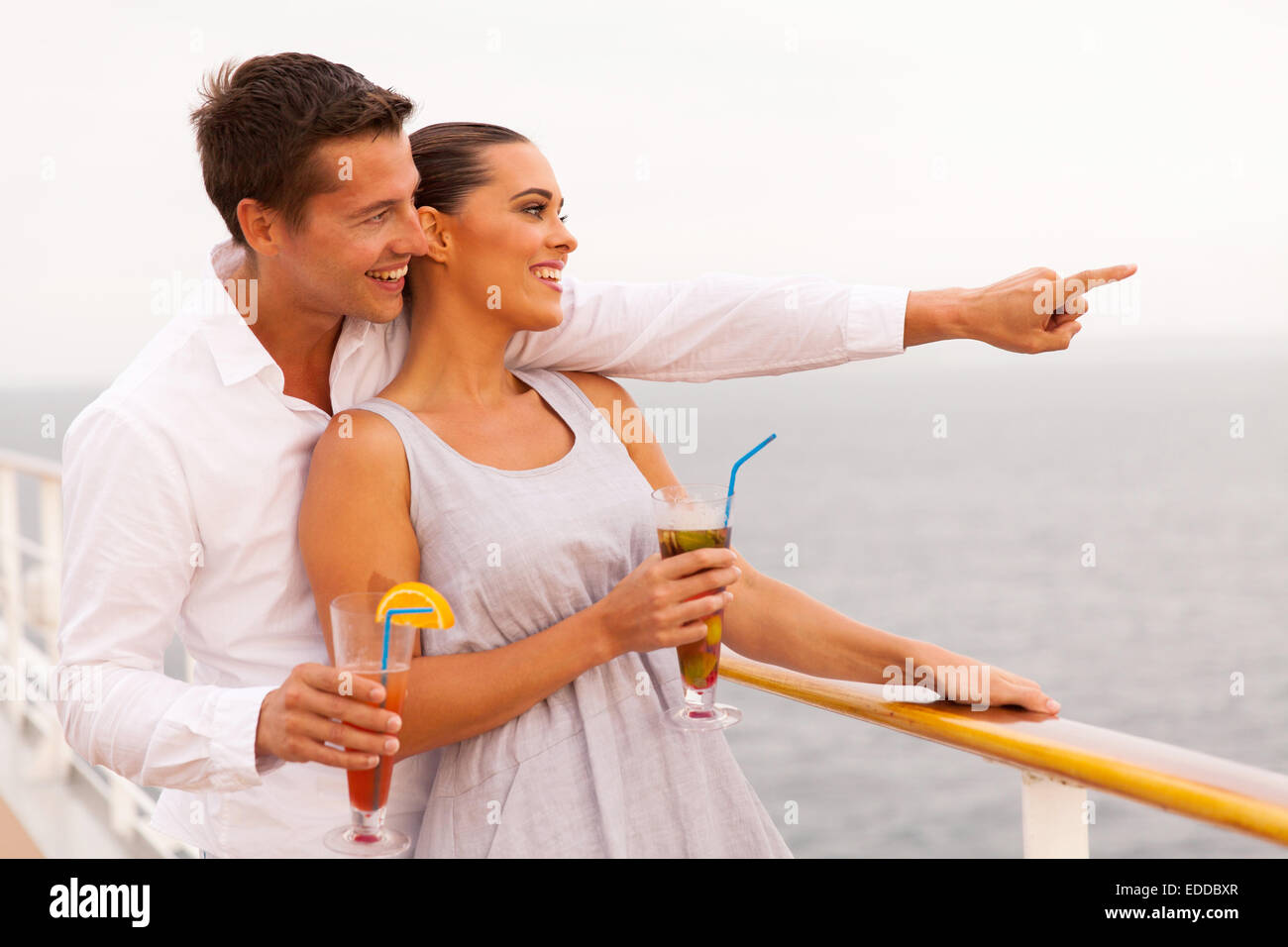 cheerful couple with cocktails enjoying sea view from cruise ship Stock ...