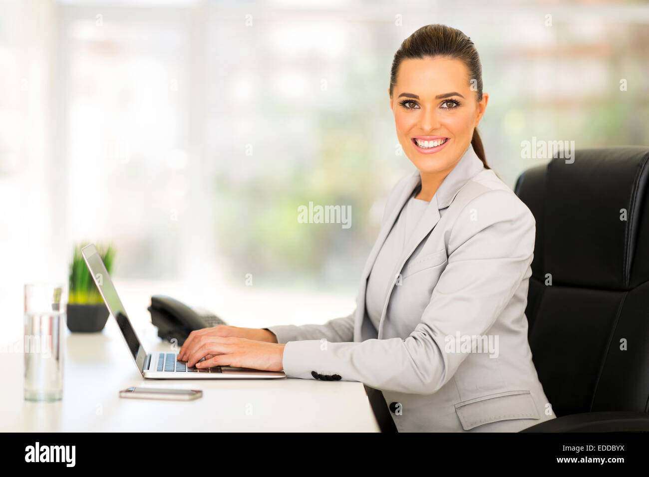 pretty female corporate worker working in office Stock Photo - Alamy