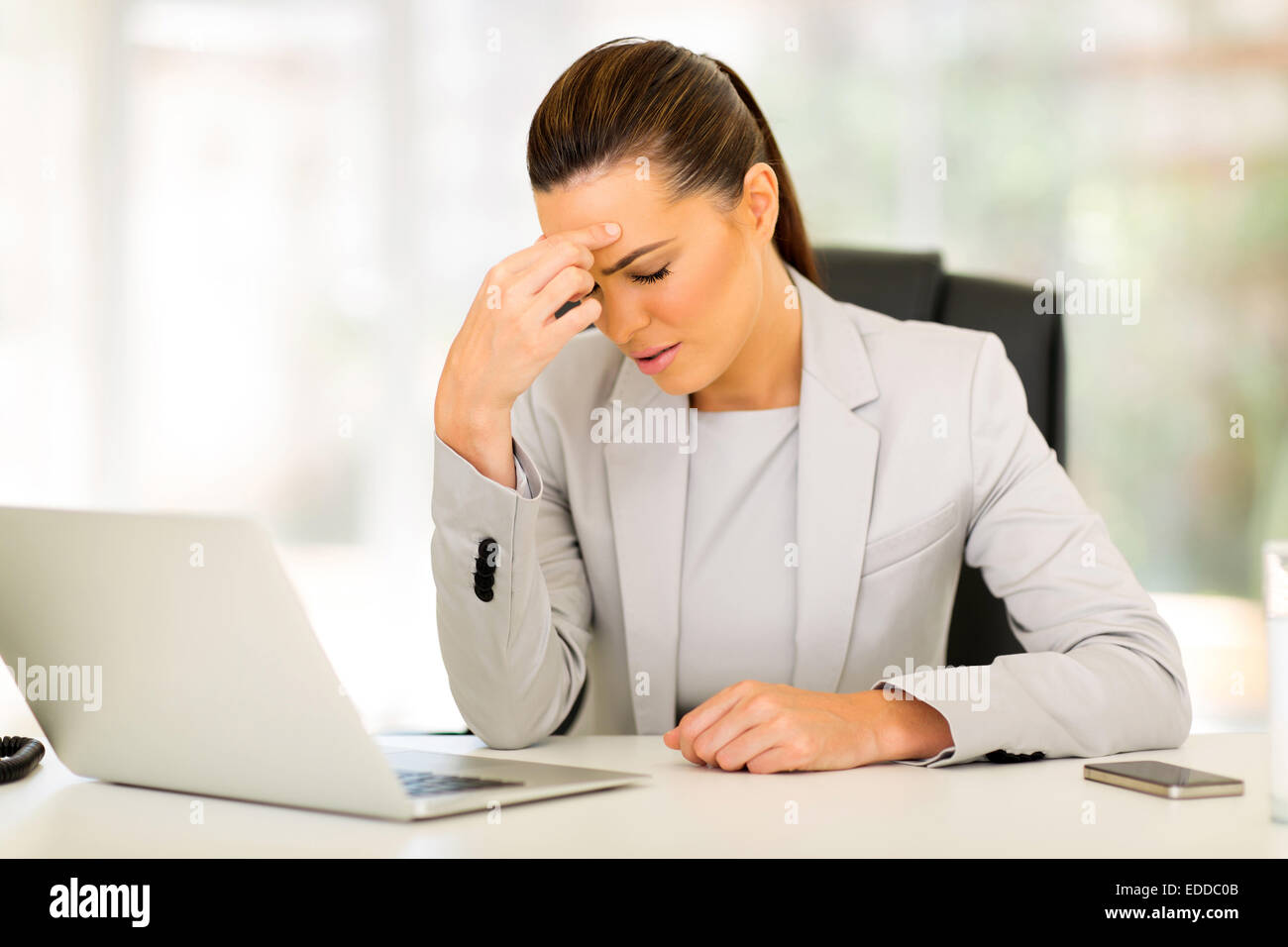 young businesswoman having headache at work Stock Photo - Alamy