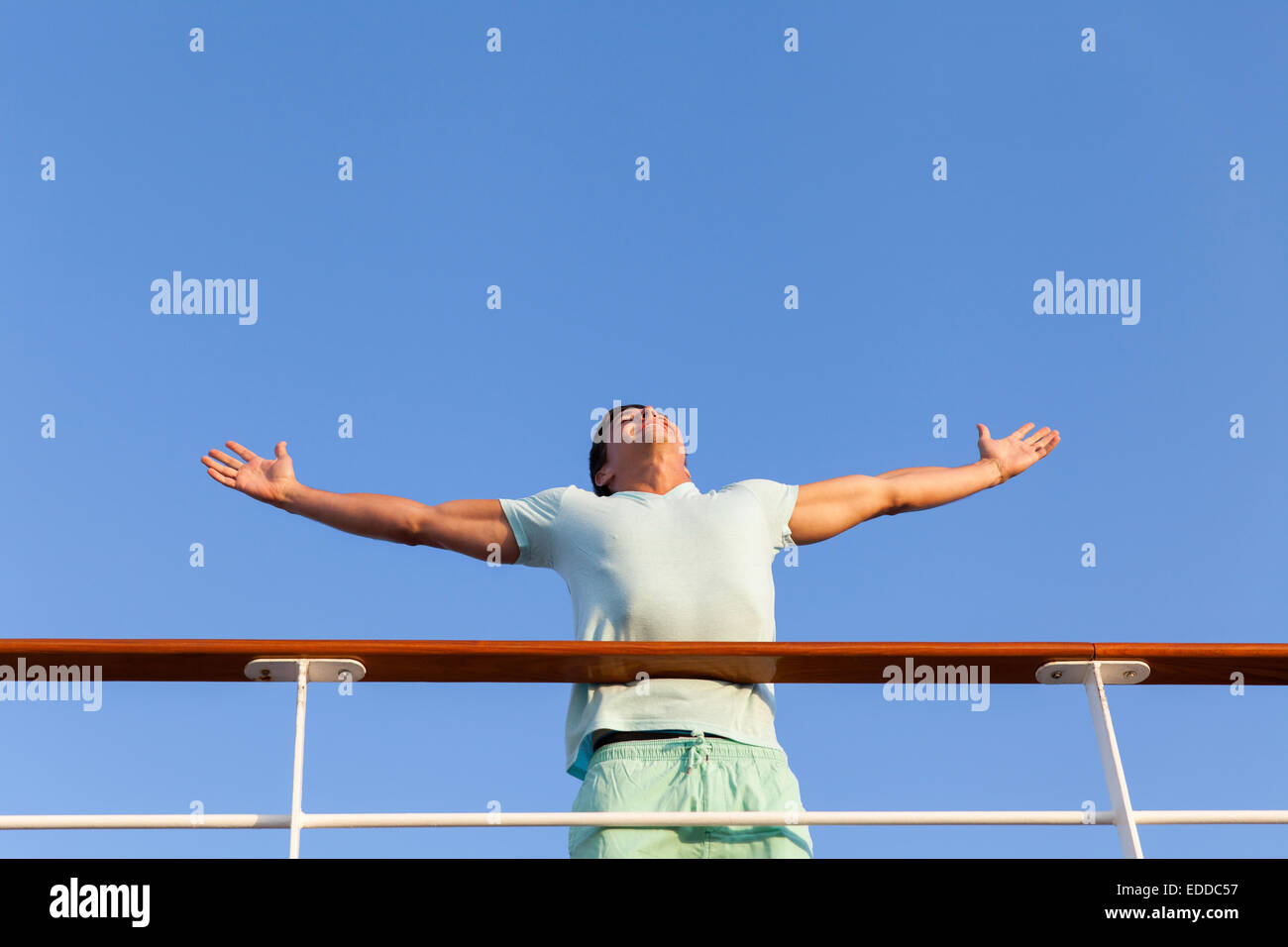 young man with arms outstretched on a cruise ship Stock Photo - Alamy