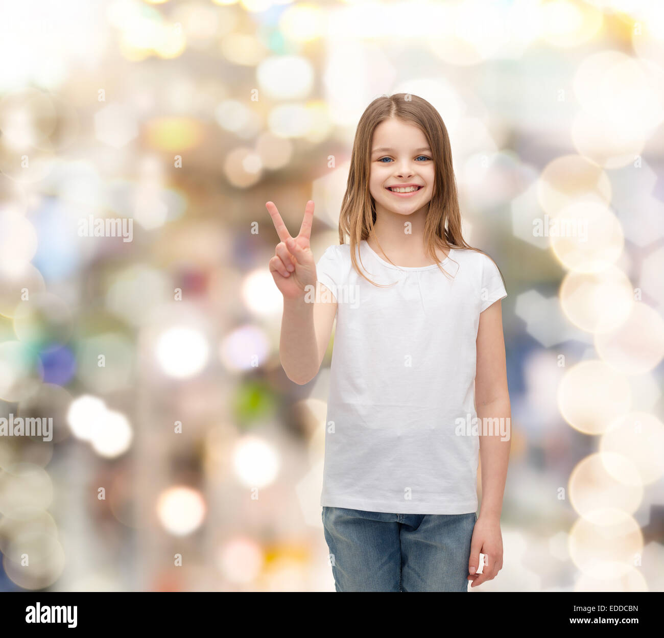 little girl in white t-shirt showing peace gesture Stock Photo - Alamy