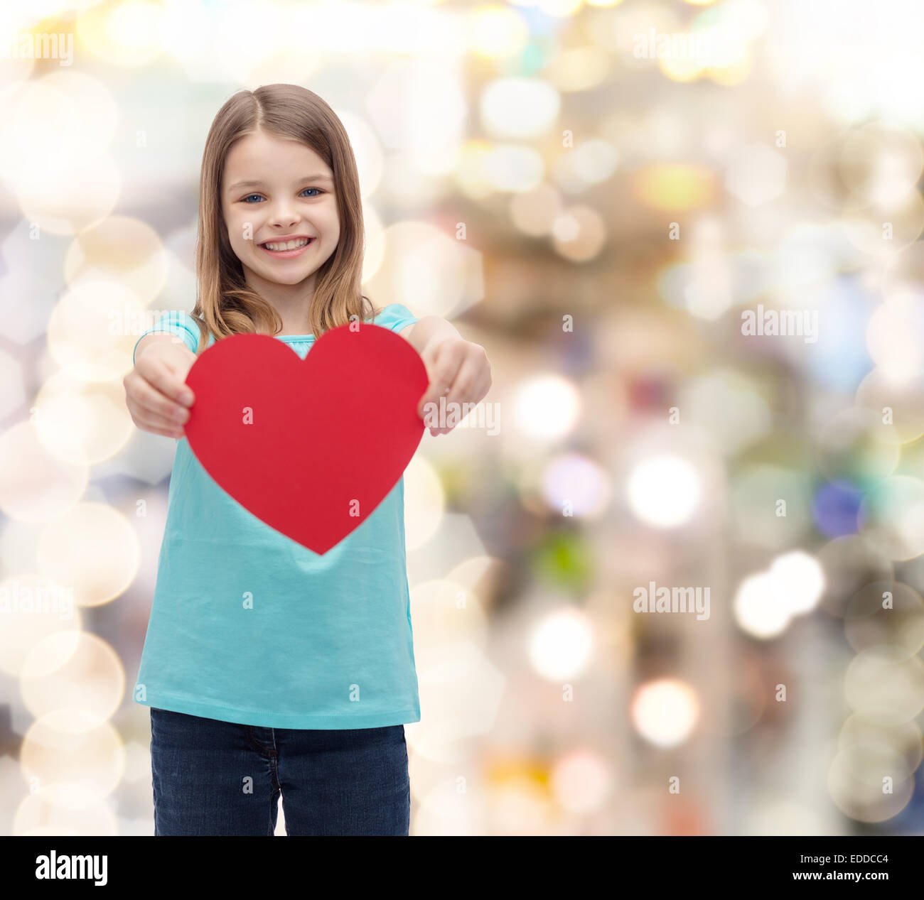 smiling little girl giving red heart Stock Photo - Alamy
