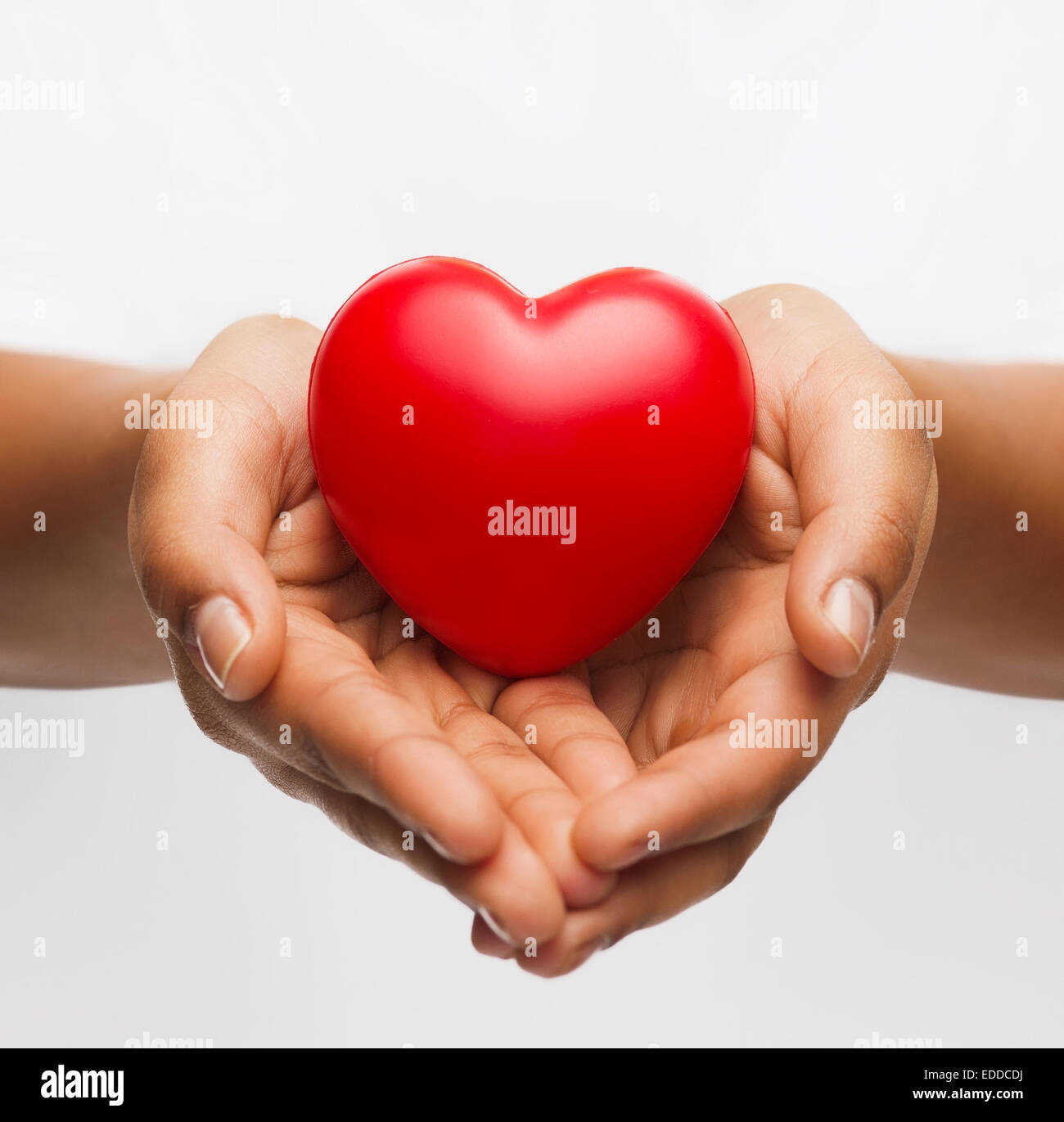 female hands with small red heart Stock Photo - Alamy