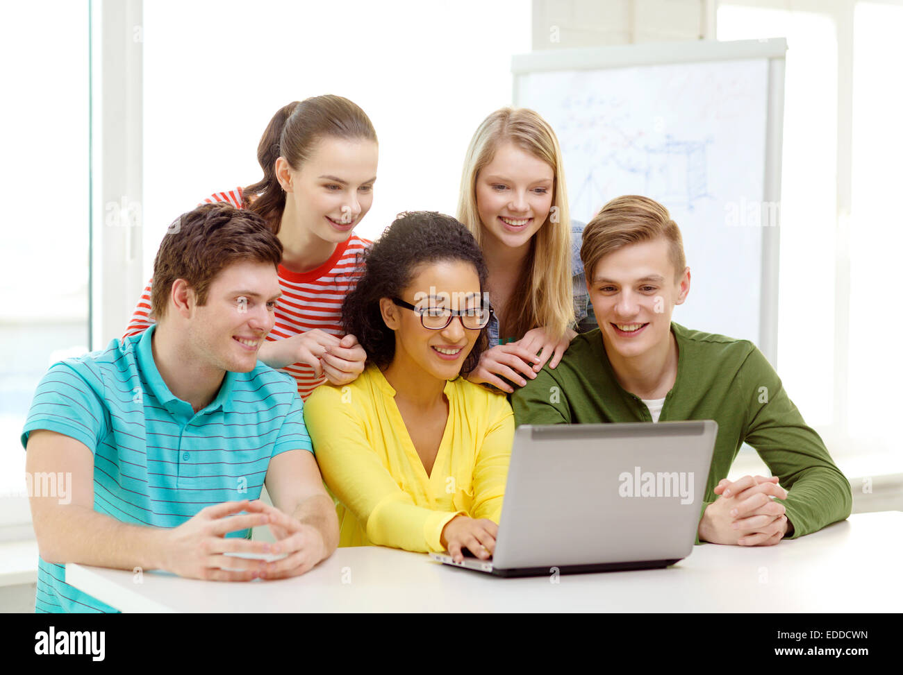 smiling students looking at laptop at school Stock Photo - Alamy