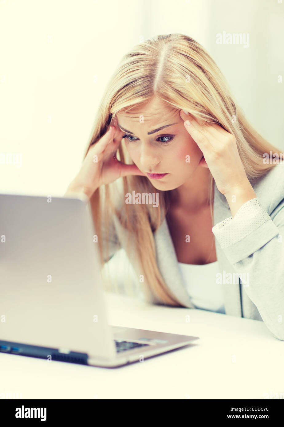 stressed woman with laptop Stock Photo - Alamy
