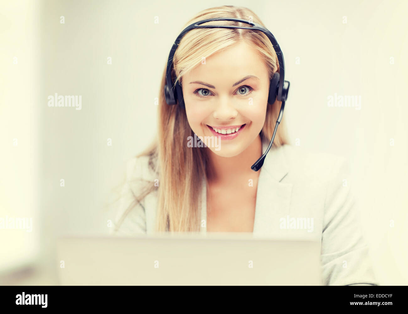friendly female helpline operator with laptop Stock Photo - Alamy