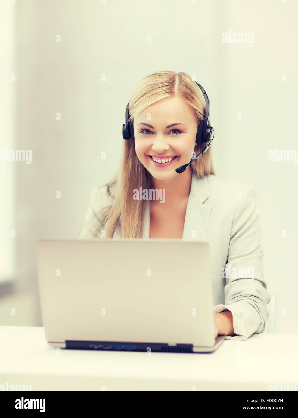 friendly female helpline operator with laptop Stock Photo - Alamy