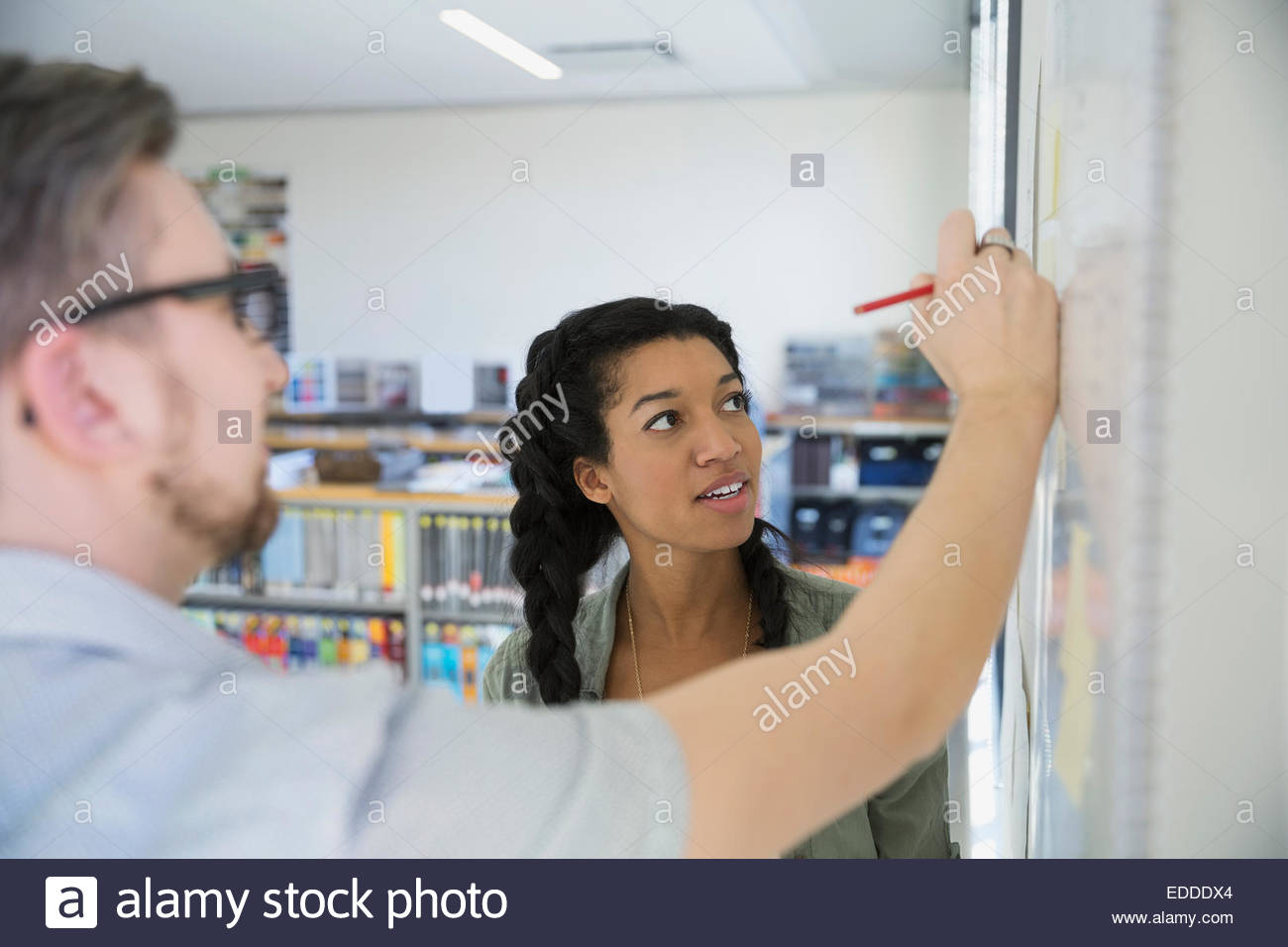 Group brainstorming on whiteboard hi-res stock photography and images ...