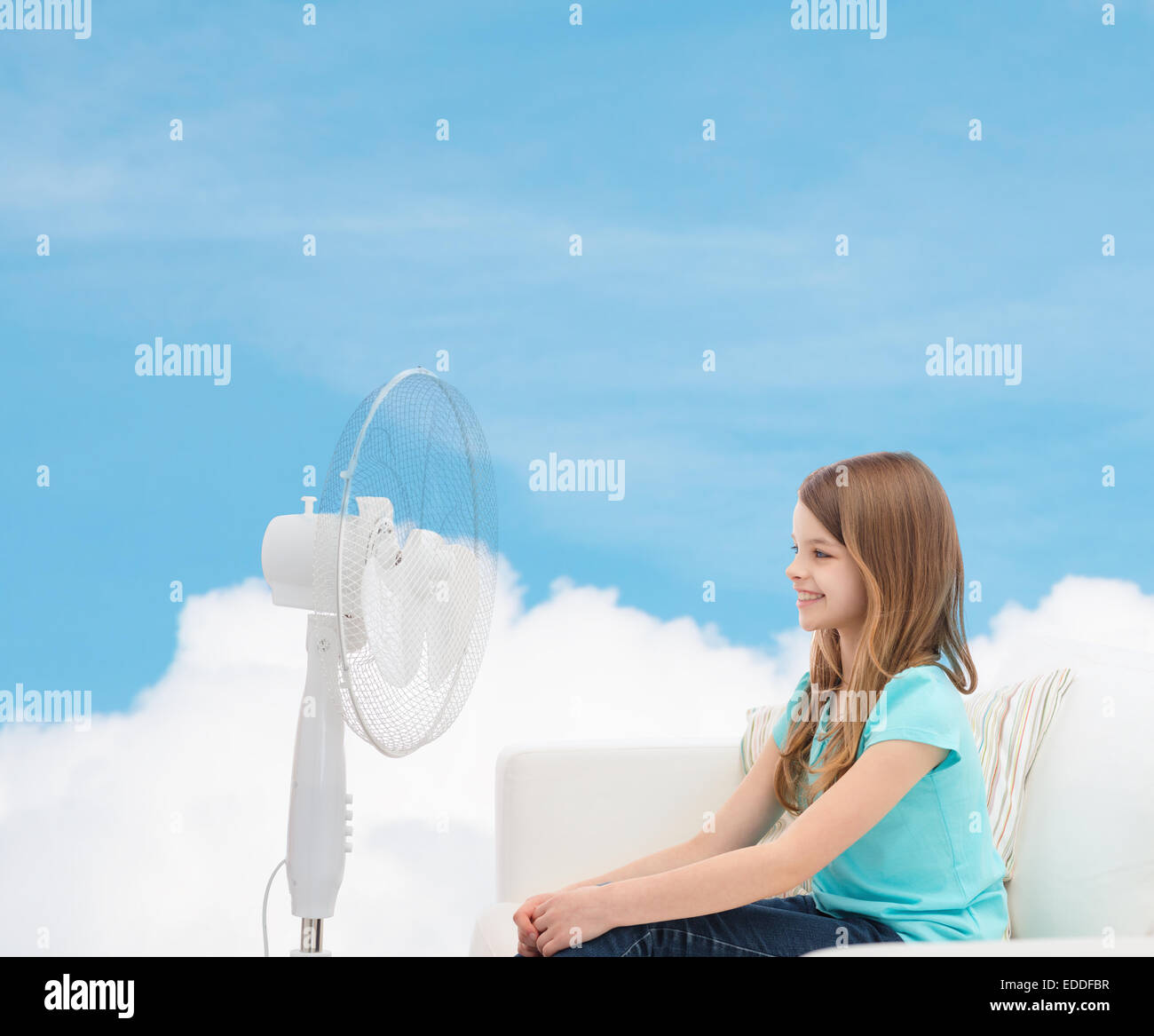 smiling little girl with big fan at home Stock Photo - Alamy