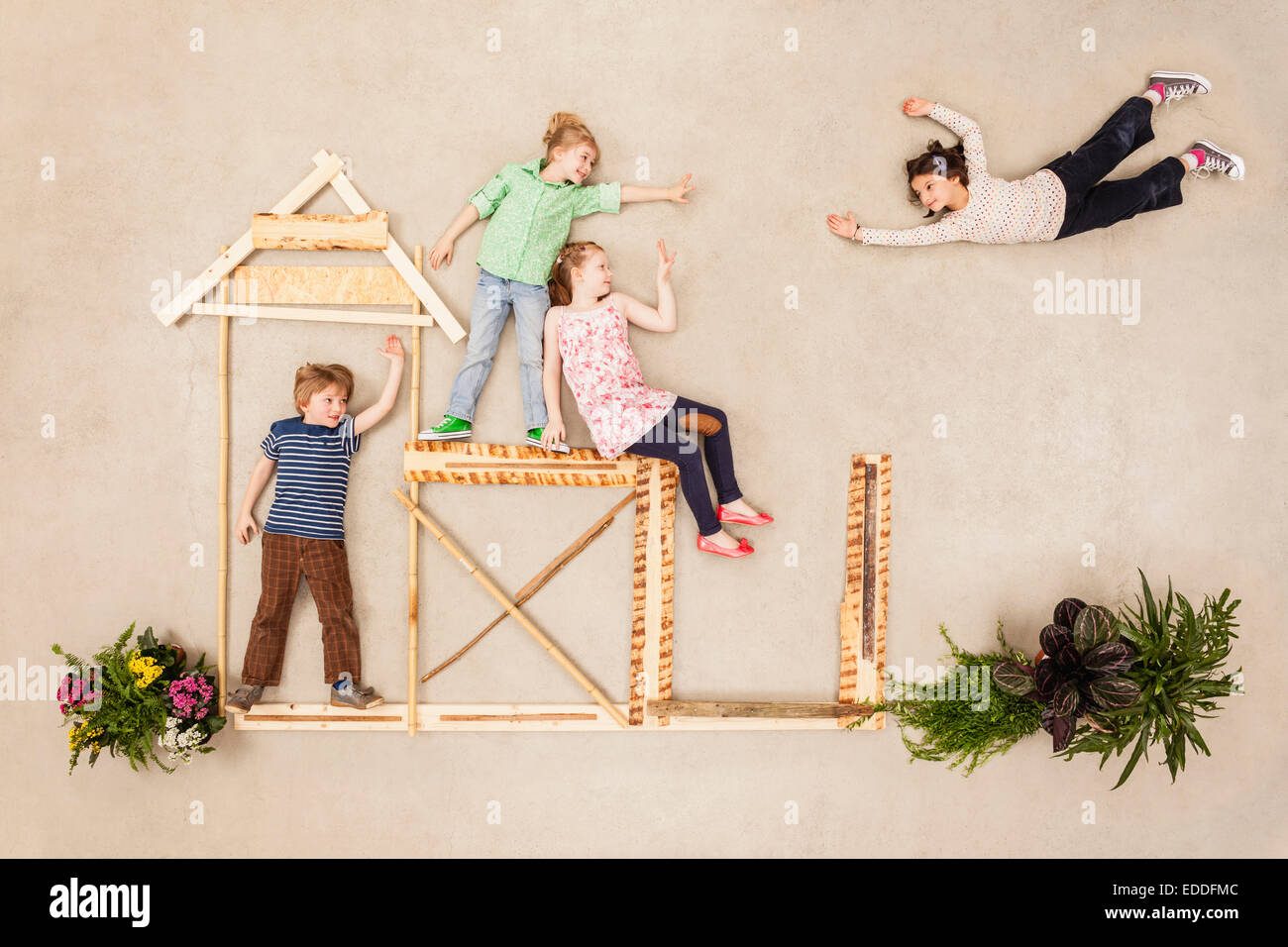 Kids playing outdoor, building wooden hut Stock Photo - Alamy