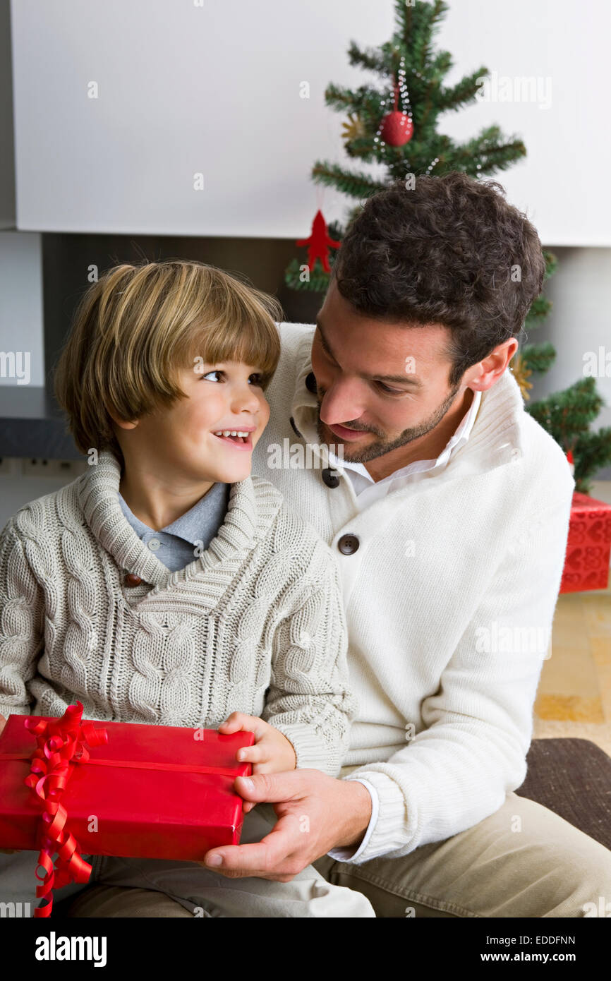 Father giving his son Christmas present Stock Photo - Alamy