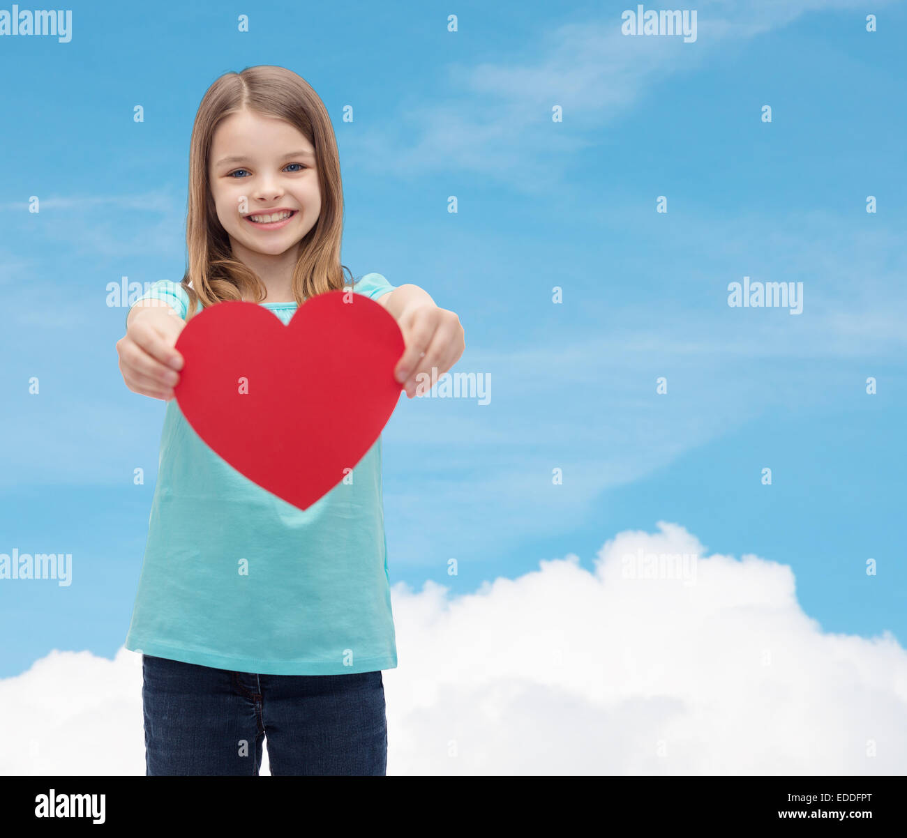 smiling little girl giving red heart Stock Photo - Alamy