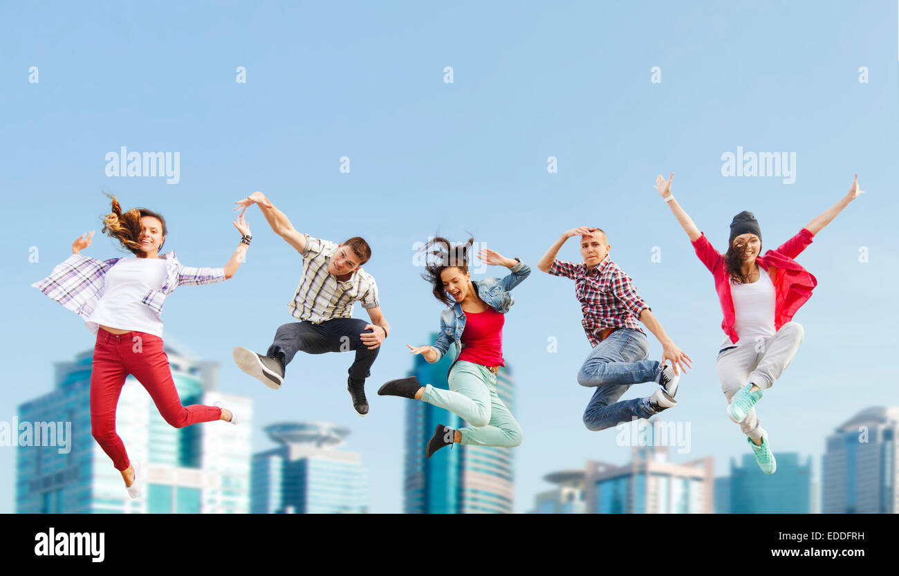 group of teenagers jumping Stock Photo - Alamy
