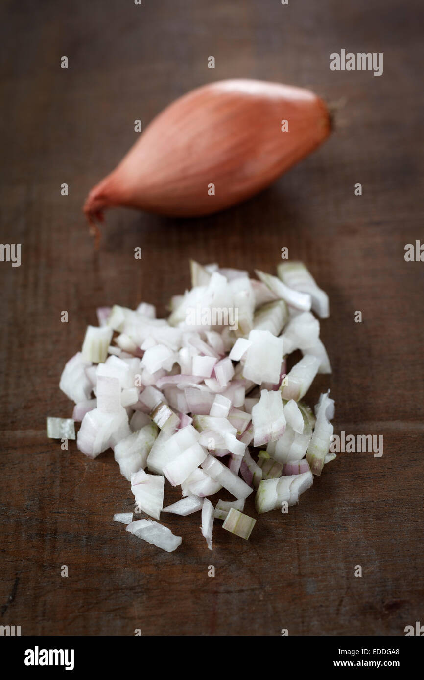 Whole and chopped shallot on brown ground Stock Photo - Alamy