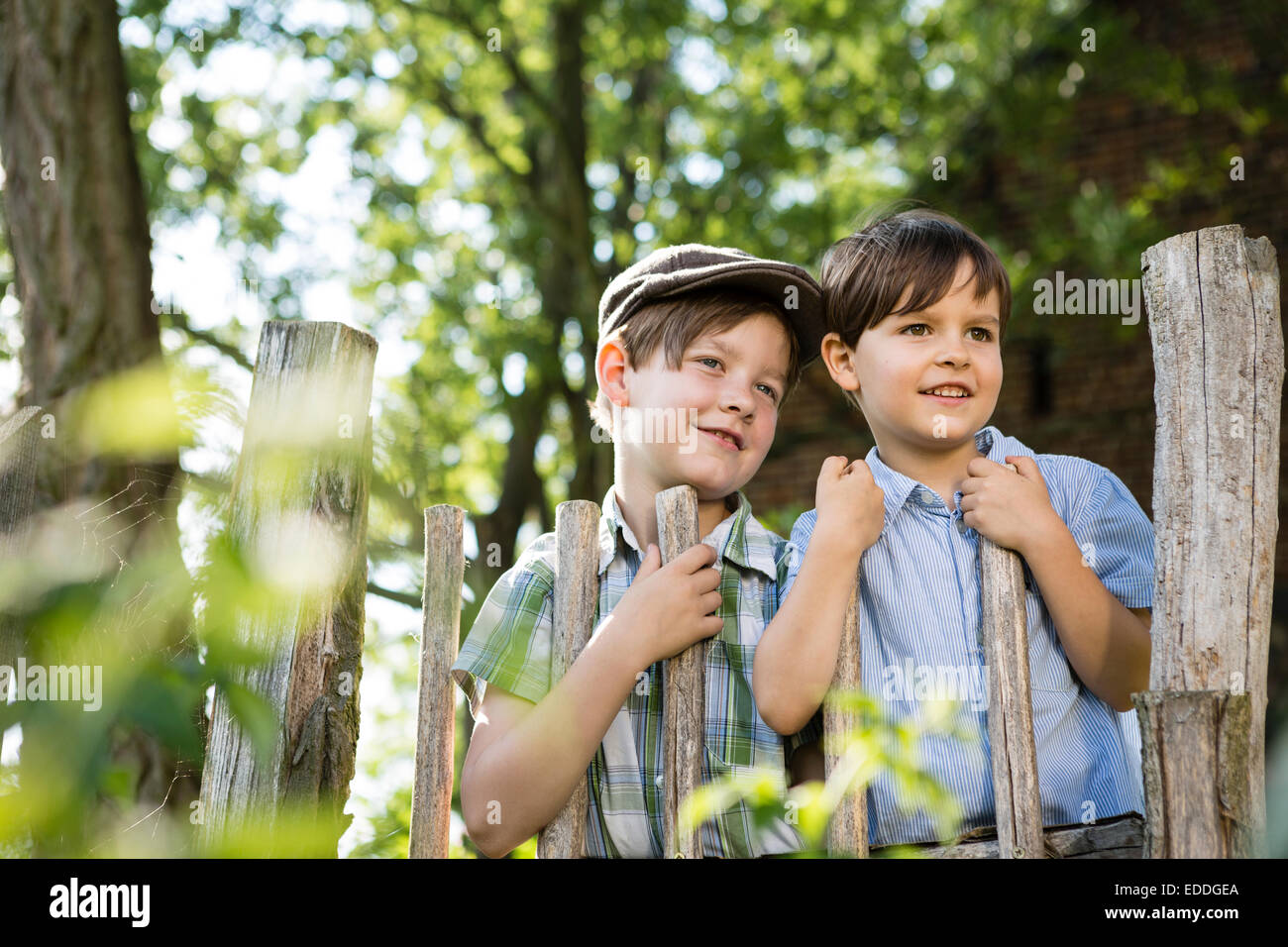 Smiling boys behind fence hi-res stock photography and images - Alamy