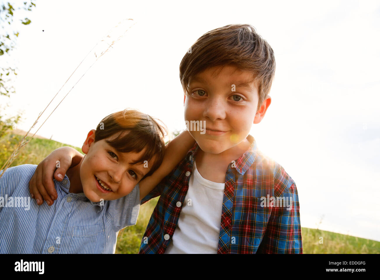 Portrait of two smiling little boys at backlight Stock Photo - Alamy