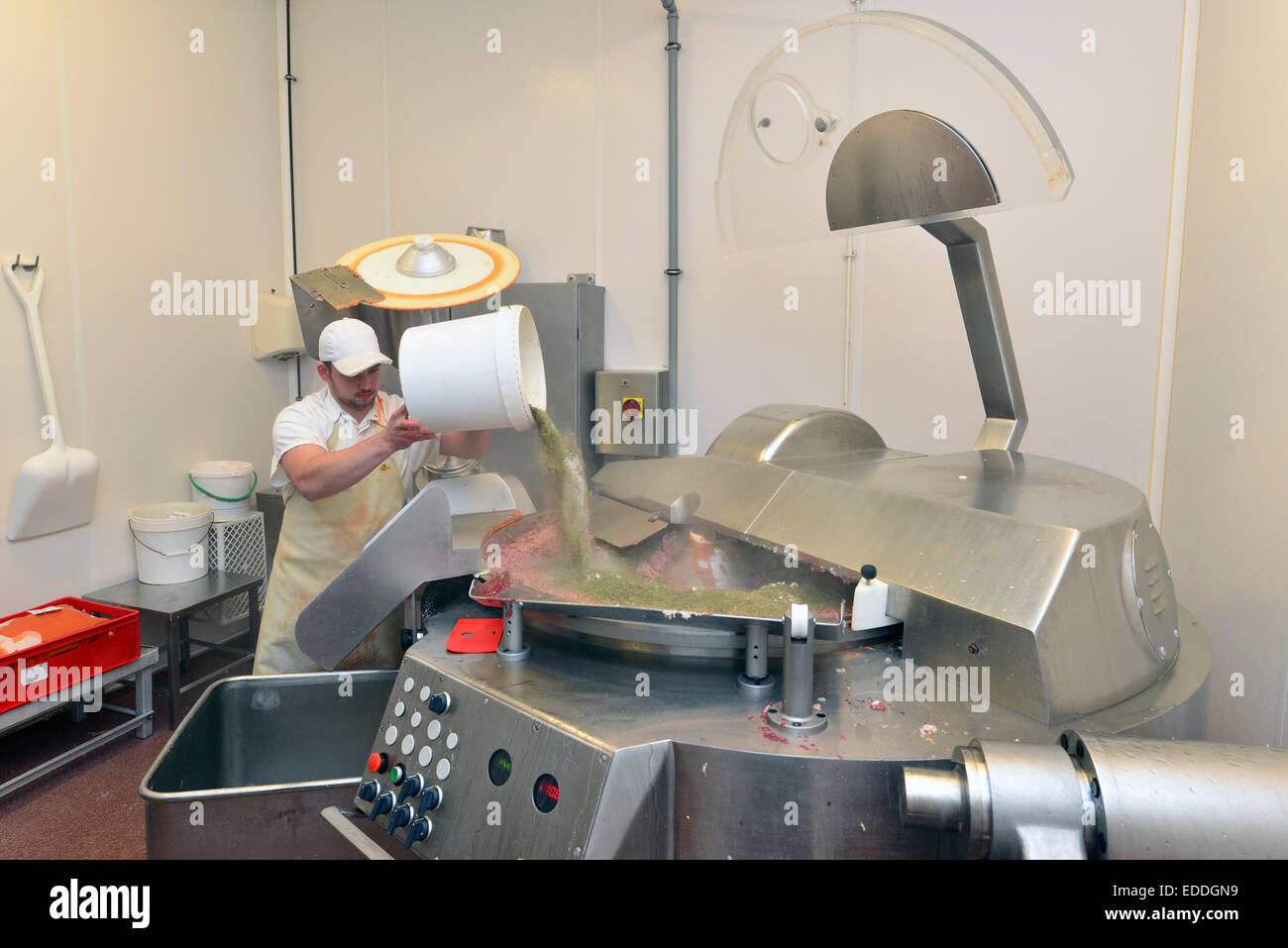 Man pouring spices into silent cutter in a butchery Stock Photo - Alamy