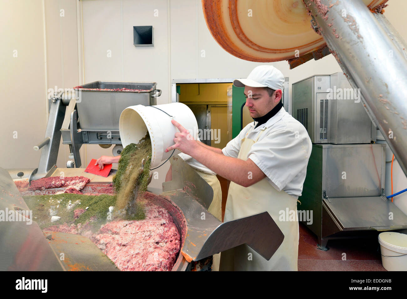 Man pouring spices into silent cutter in a butchery Stock Photo - Alamy