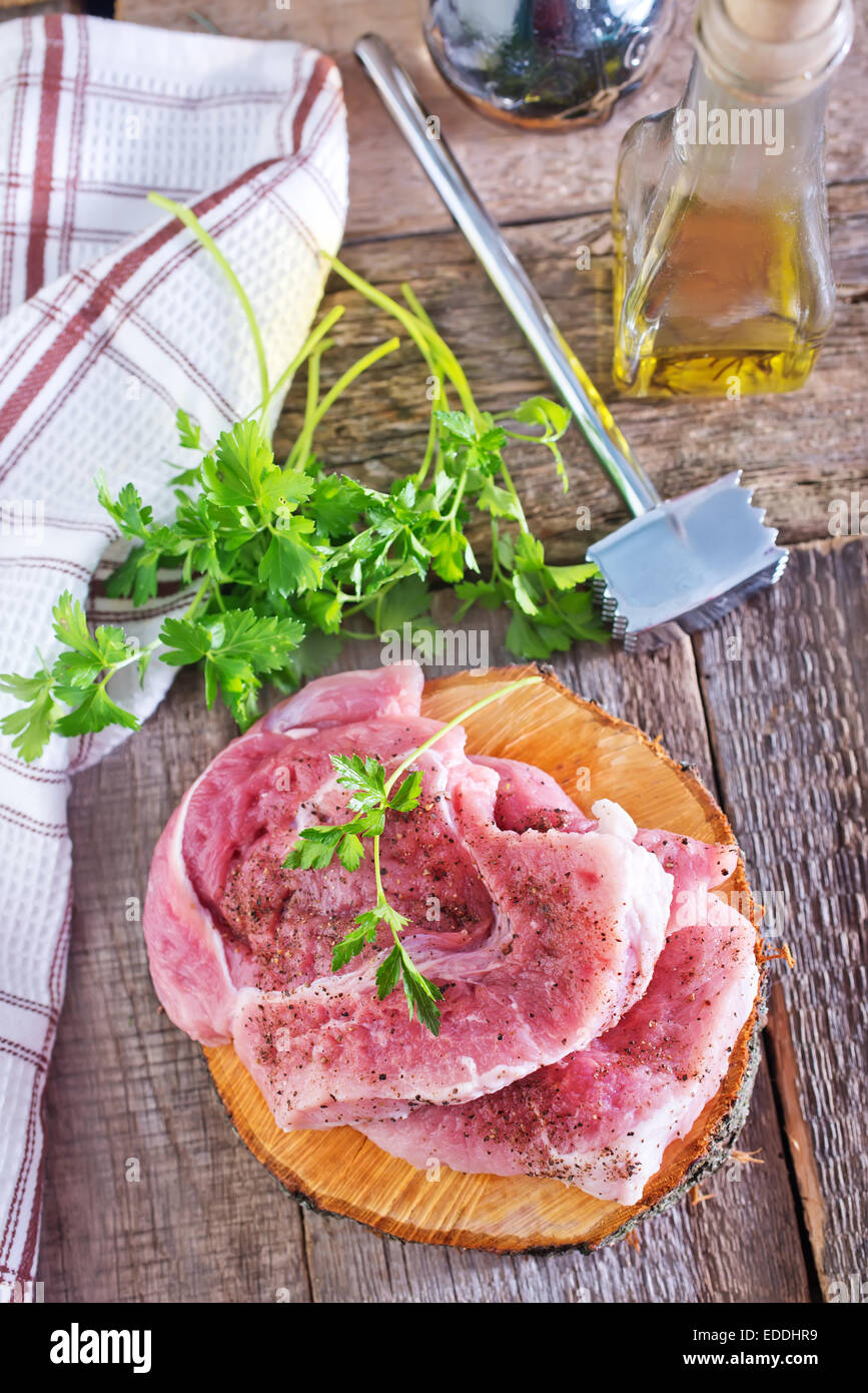 raw meat on the wooden board and on a table Stock Photo - Alamy