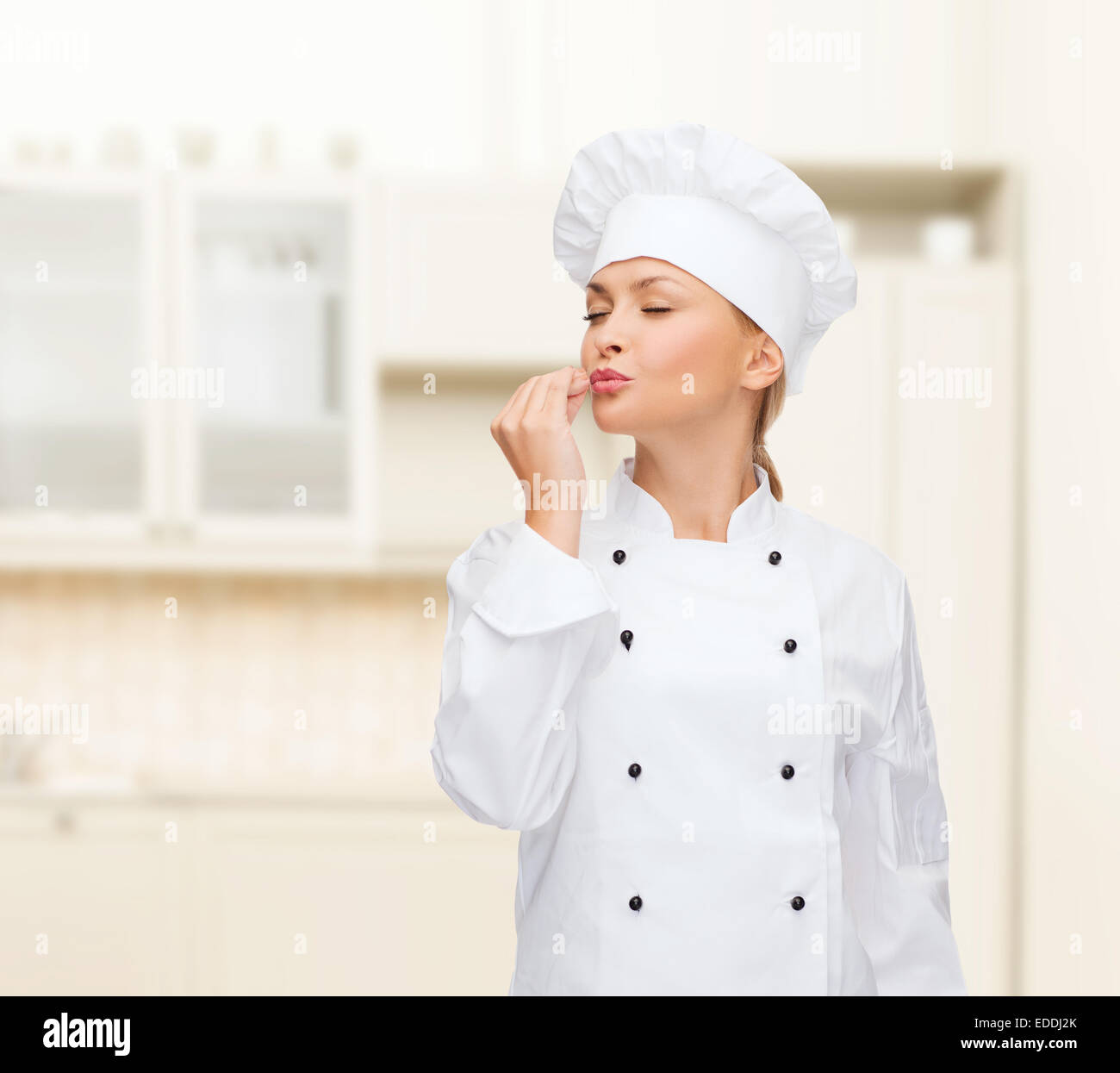 smiling female chef showing delicious sign Stock Photo - Alamy